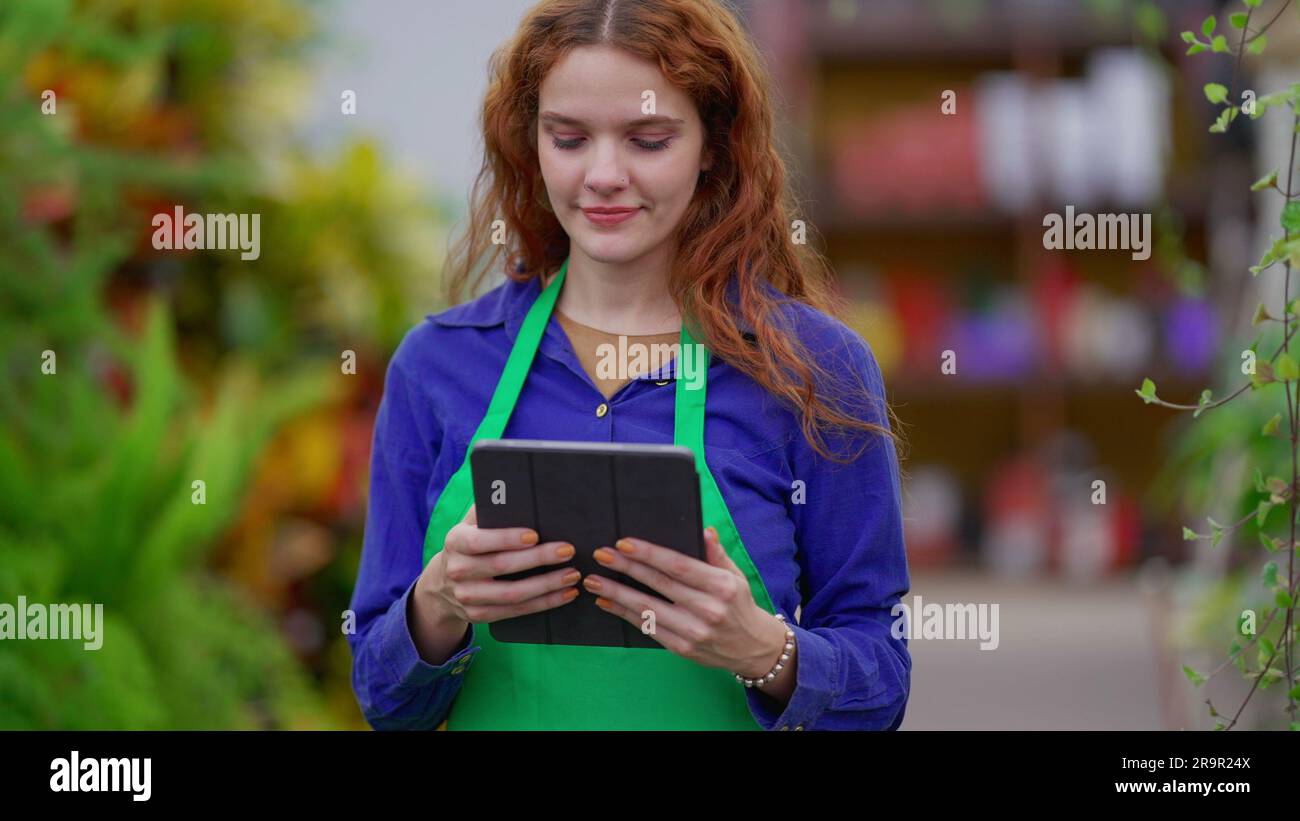 Joyful Female Manager Conducting Inventory Check in Plant Retail Store ...