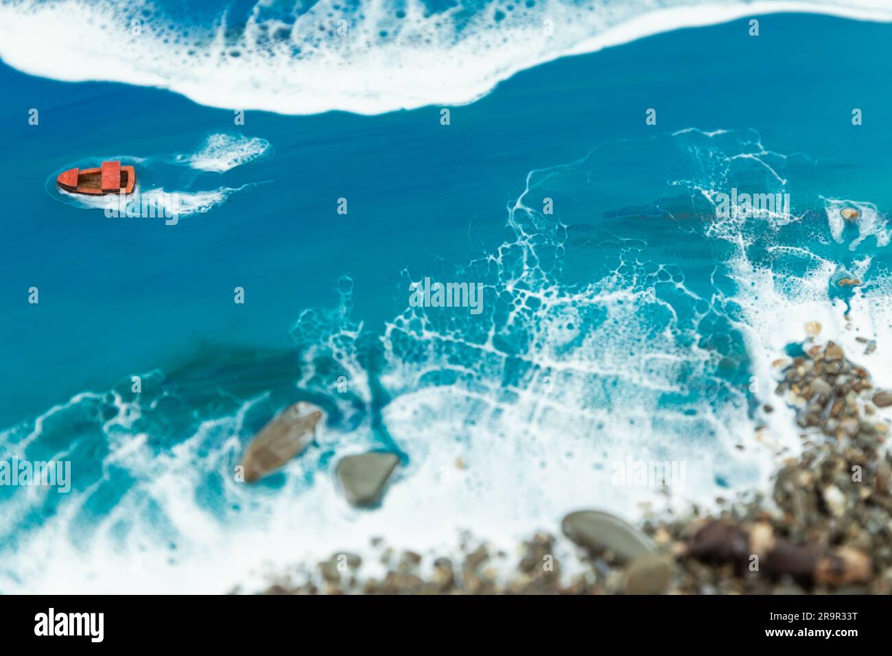 Epoxy art composition with blue ocean waves, boat and stone beach Stock ...