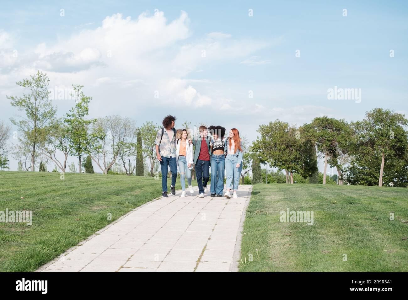 Group of students walking around the university campus and taking a ...