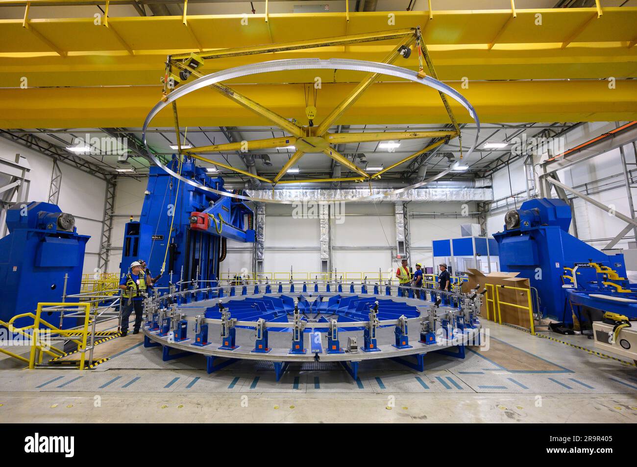 NASA technicians move a ring for the Exploration Upper Stage of SLS at ...
