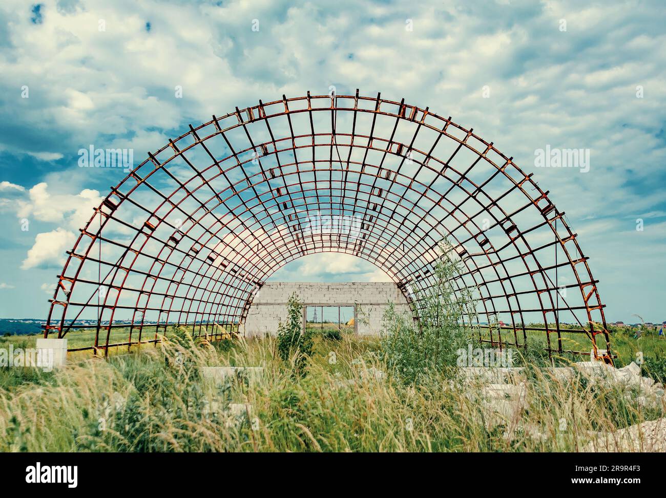 metal arch is rusty, the abandoned construction of the metal hangar is ...