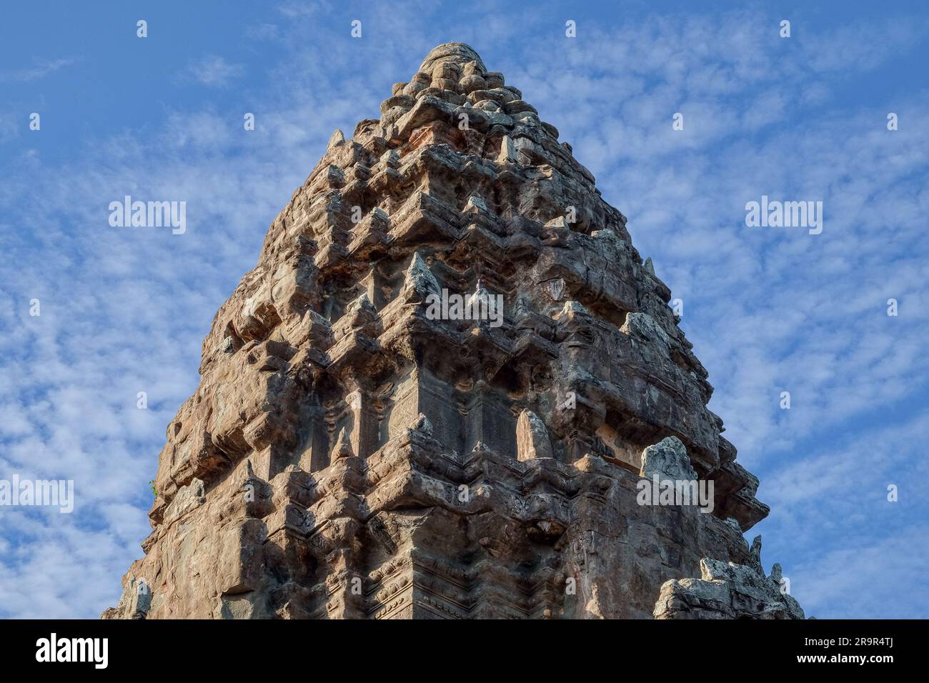 The tall beautifully decorated stone tower of the Khmer temple of ...