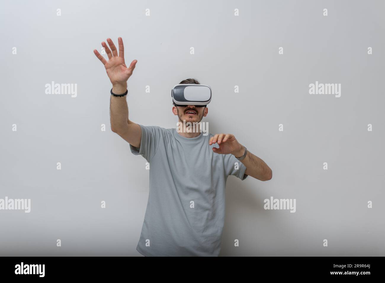 Futuristic man wearing virtual reality glasses interacts with the air ...
