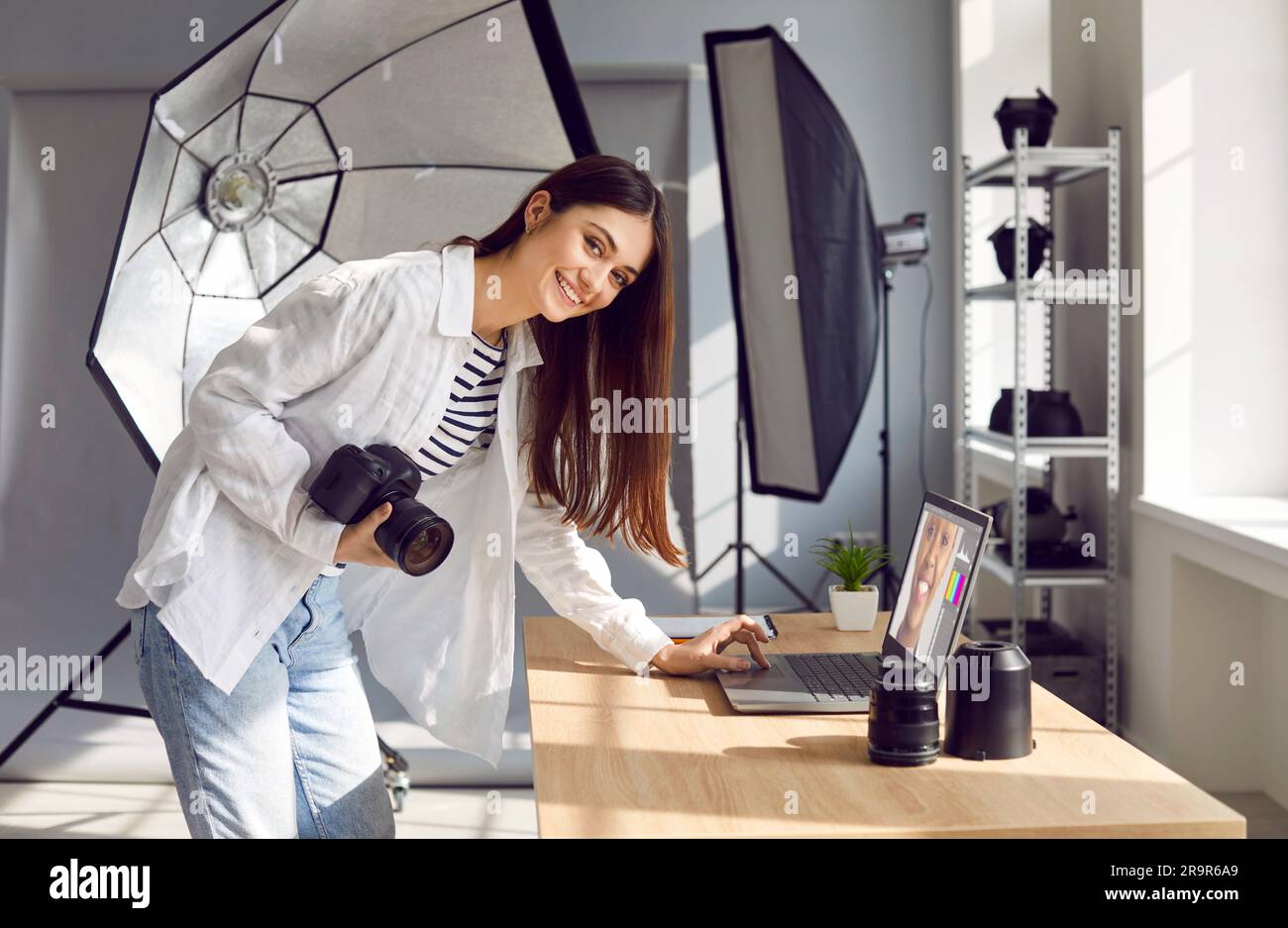 Female photographer editing photos on hi-res stock photography and ...
