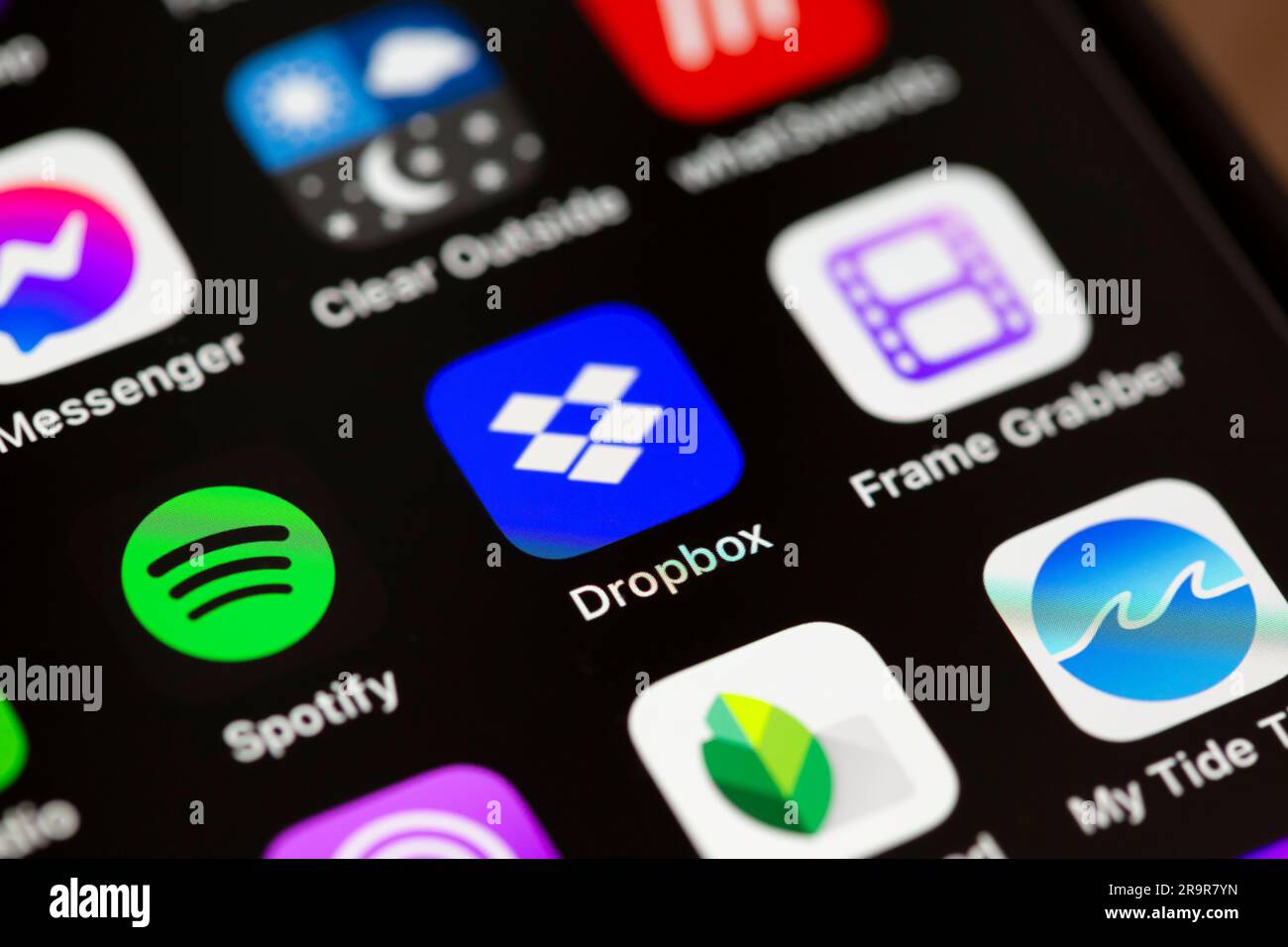 A close up of the Dropbox app icon on an Apple smartphone screen Stock ...