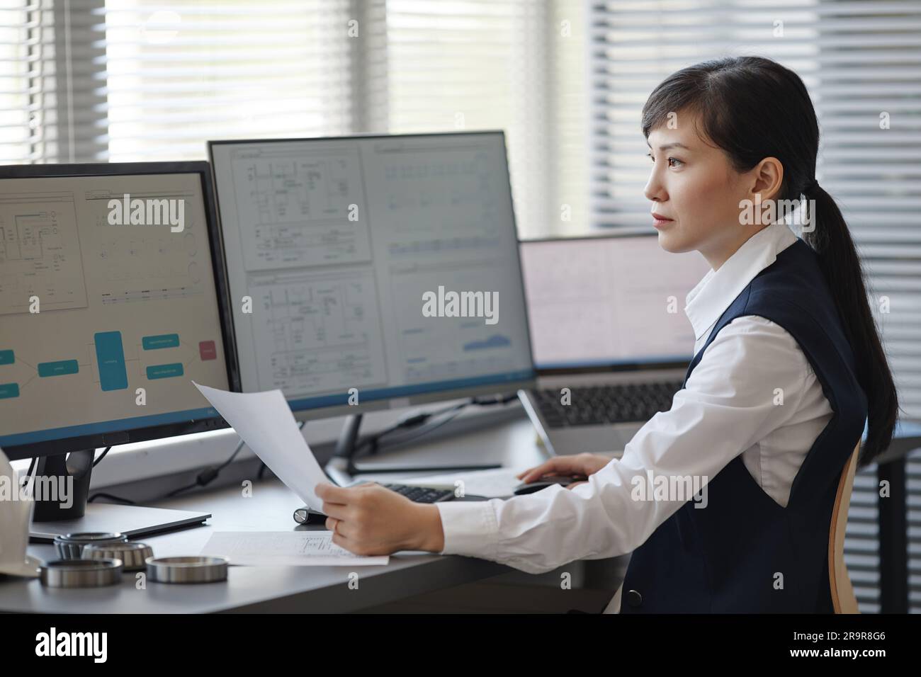 Side view portrait of Asian woman as female engineer using computer ...