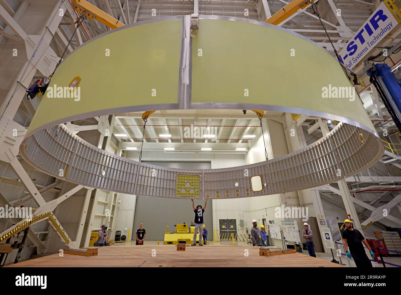 Technicians lift and inspect midbody barrel sections for the SLS ...