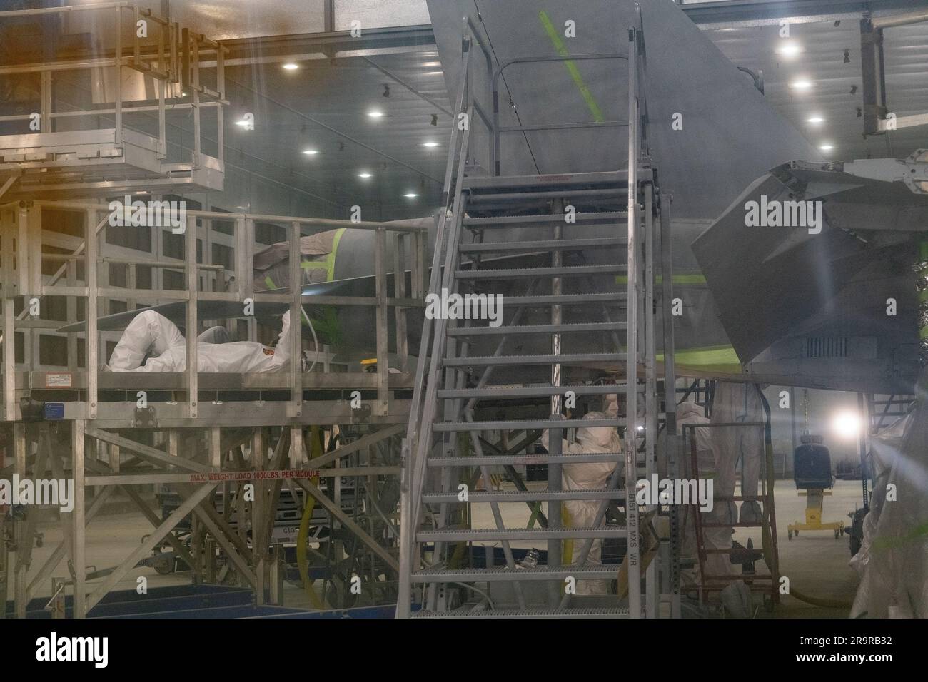 . U.S. Air Force Corrosion Control Facility personnel work to sand NASA ...