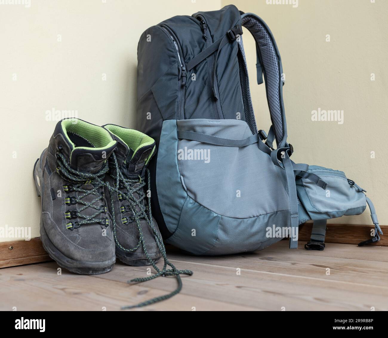 Men's lace-up mountain boots and hiking backpack are prepared for the ...