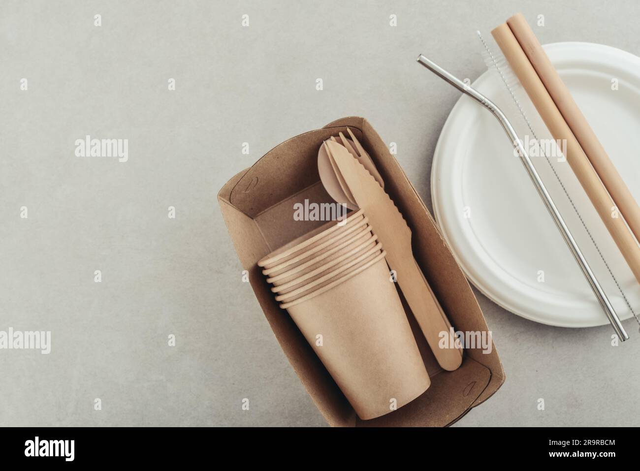 Set of eco-friendly tableware and kraft paper food packaging on light ...
