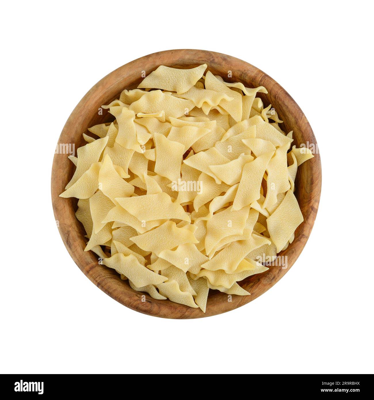 Pasta in wooden bowl isolated on white background, top view Stock Photo ...