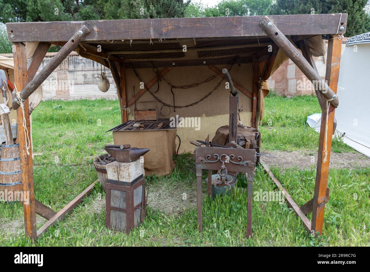 outdoor scene in horizontal view of the recreation of a blacksmith shop ...