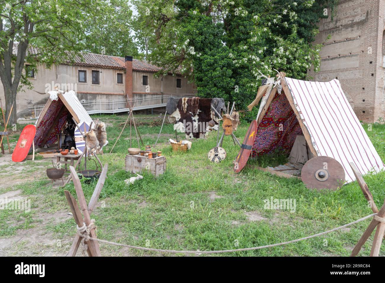 outdoor scene in horizontal view of the recreation of a military camp ...