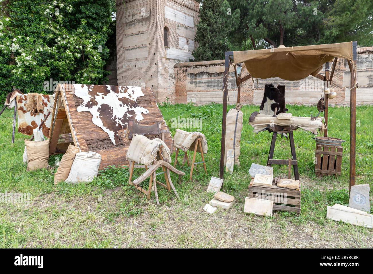 outdoor scene in horizontal view of the recreation of a stone workshop ...