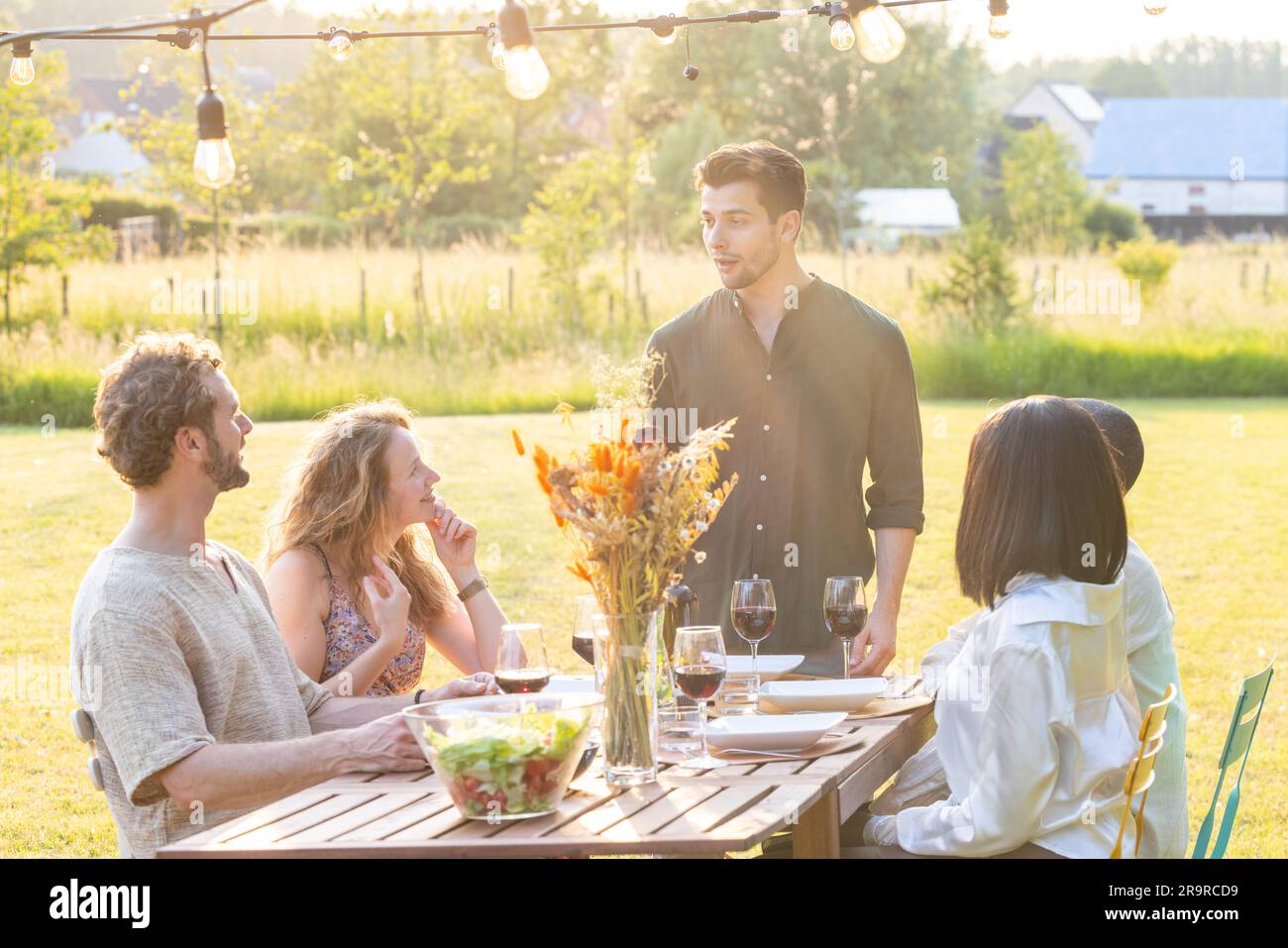 Garden Delights: Multiracial Friends Unite in Evening Feast of Fun ...
