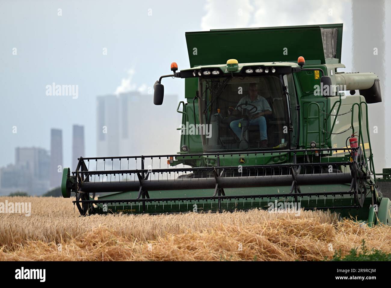 Pulheim, Germany. 28th June, 2023. A farmer harvests winter barley with ...