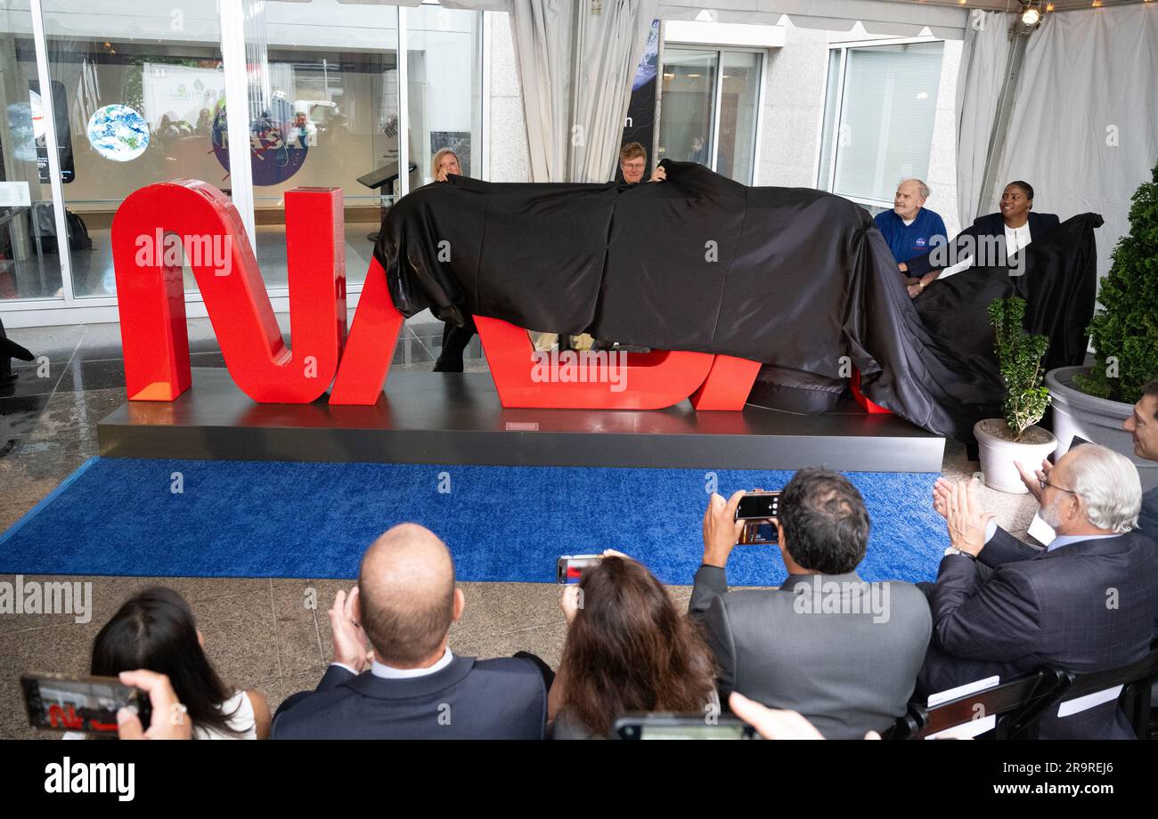 NASA’s Earth Information Center Ribbon Cutting. The NASA Worm Logo sign ...