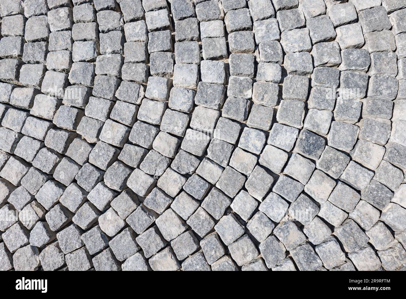 Old granite cobblestone road for texture or Top view of an old granite ...