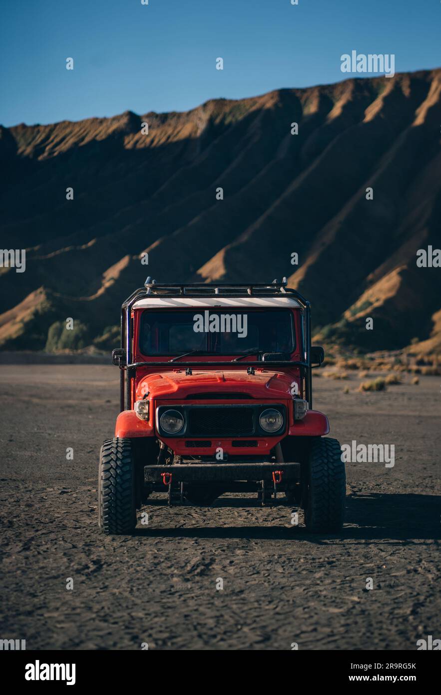 Front view of red jeep with Bromo volcano background. Semeru mountain ...