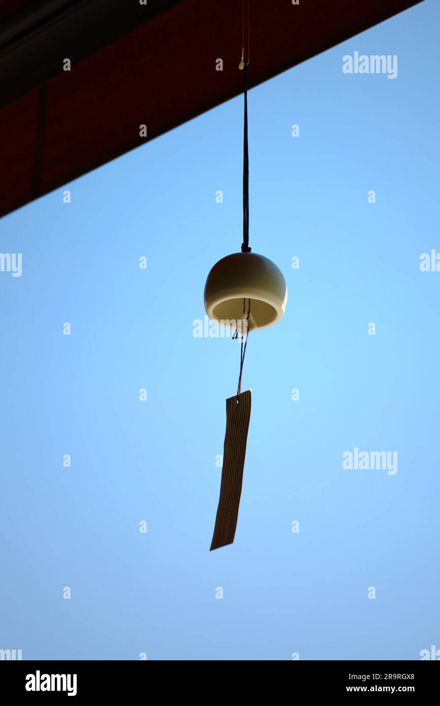The eaves of a shop where a wind chime called "Furin", a Japanese ...