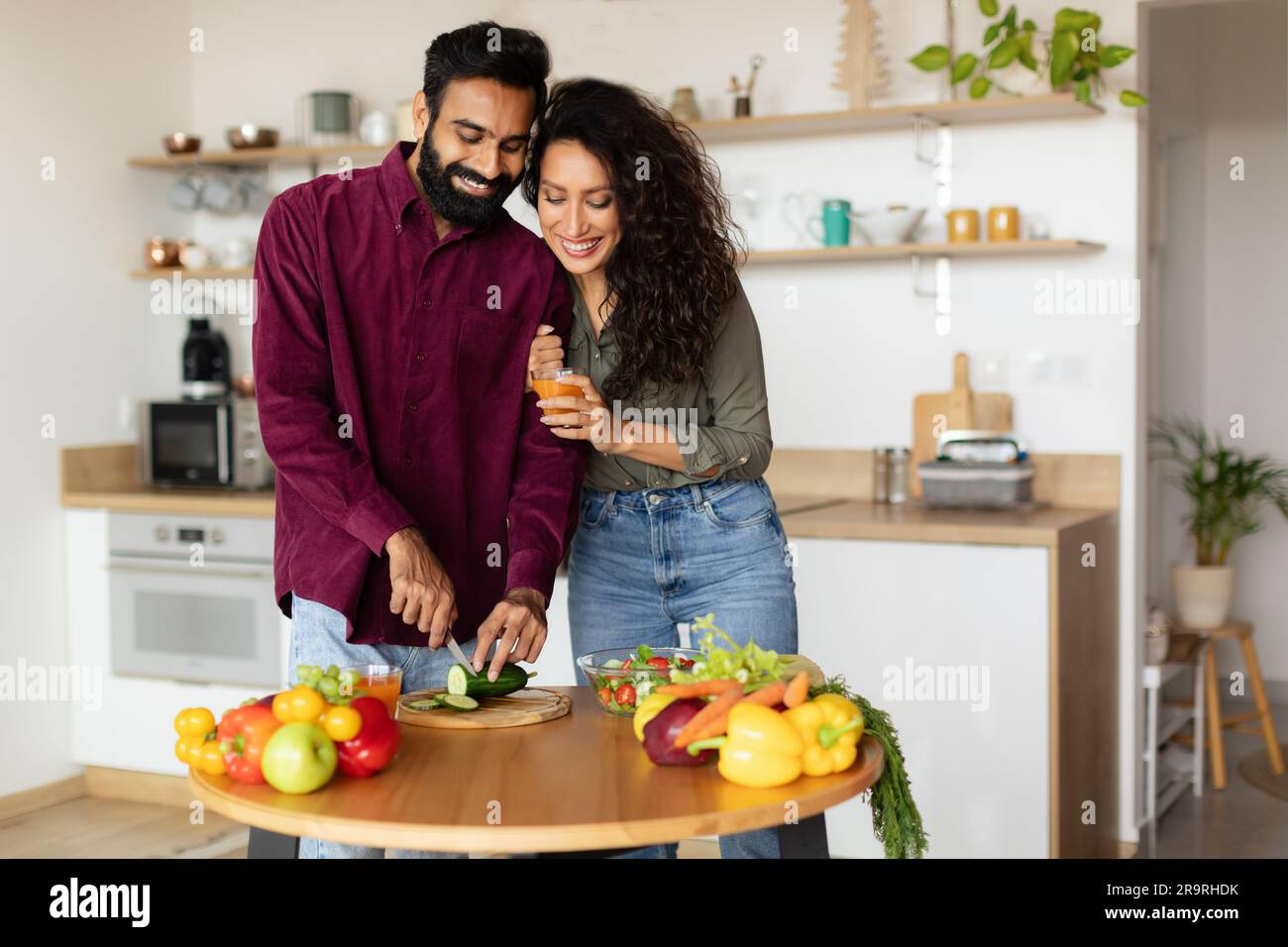 Loving arab man husband cooking delicious healthy dinner for his young ...