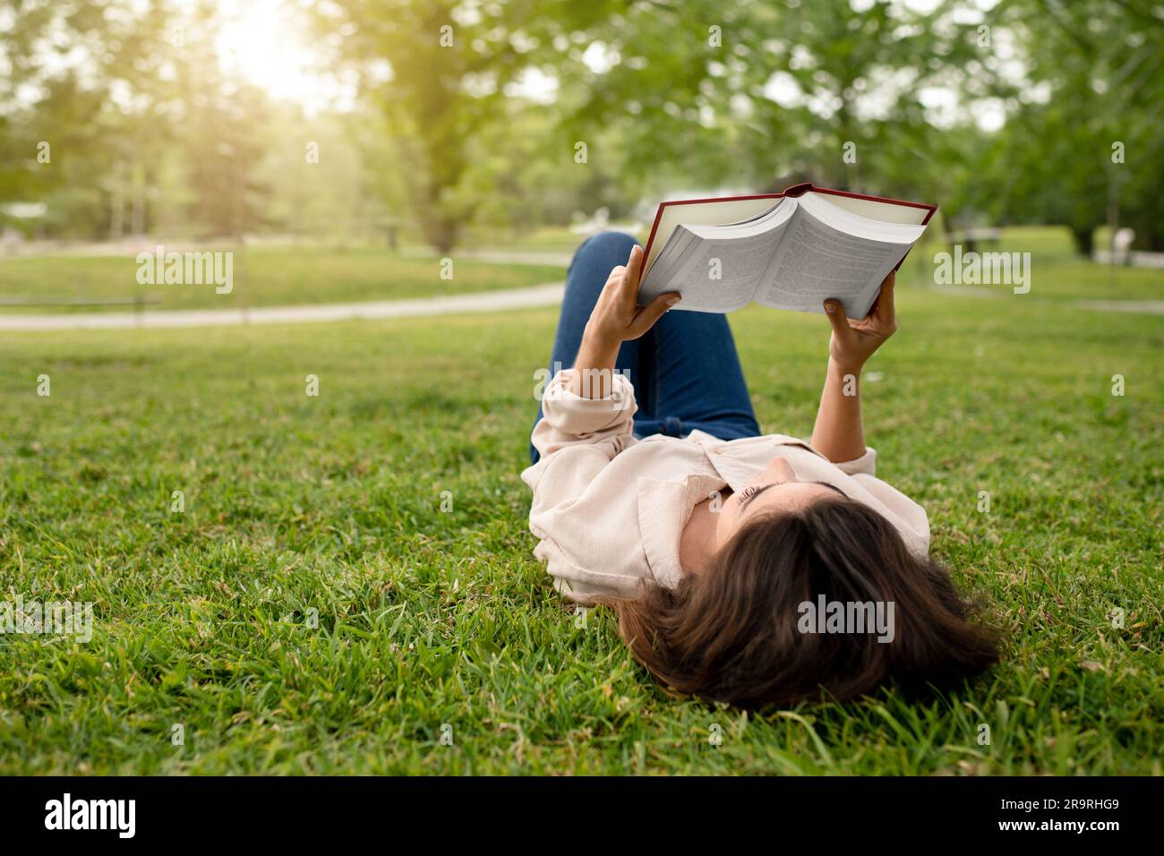 Student Young Lady Reading Book Lying On Green Grass Outdoor Stock ...