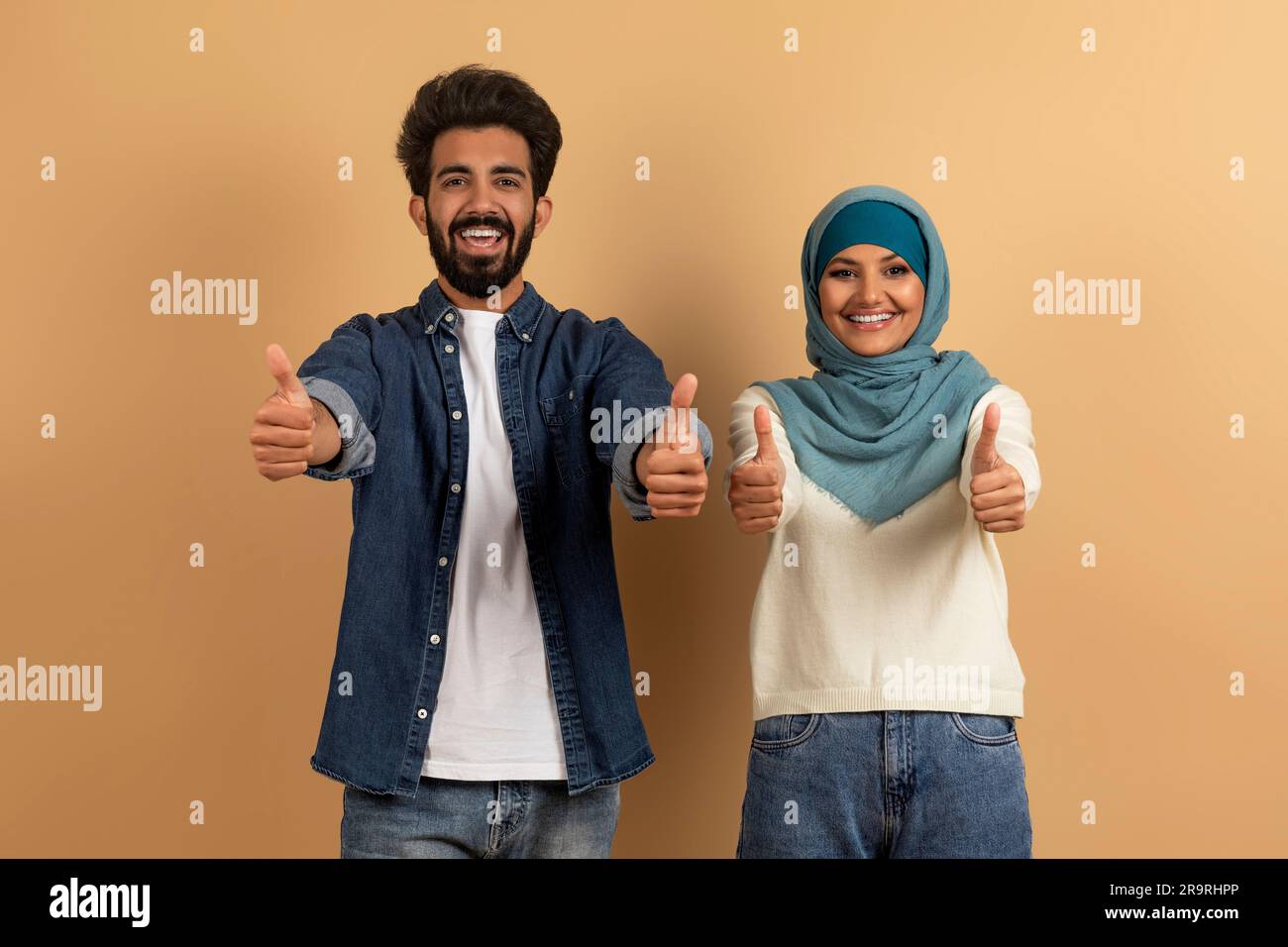 Happy Millennial Muslim Couple Showing Their Thumbs Up At Camera Stock ...