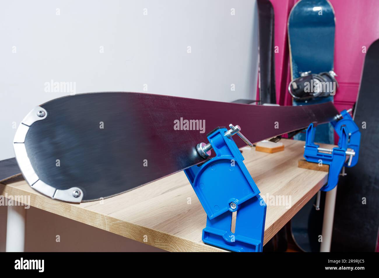 Skis ready for sharpening, attached to workbench with vises Stock Photo ...