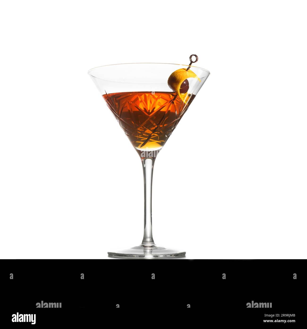 A classic Manhattan Cocktail served on a bar table with a slice of ...