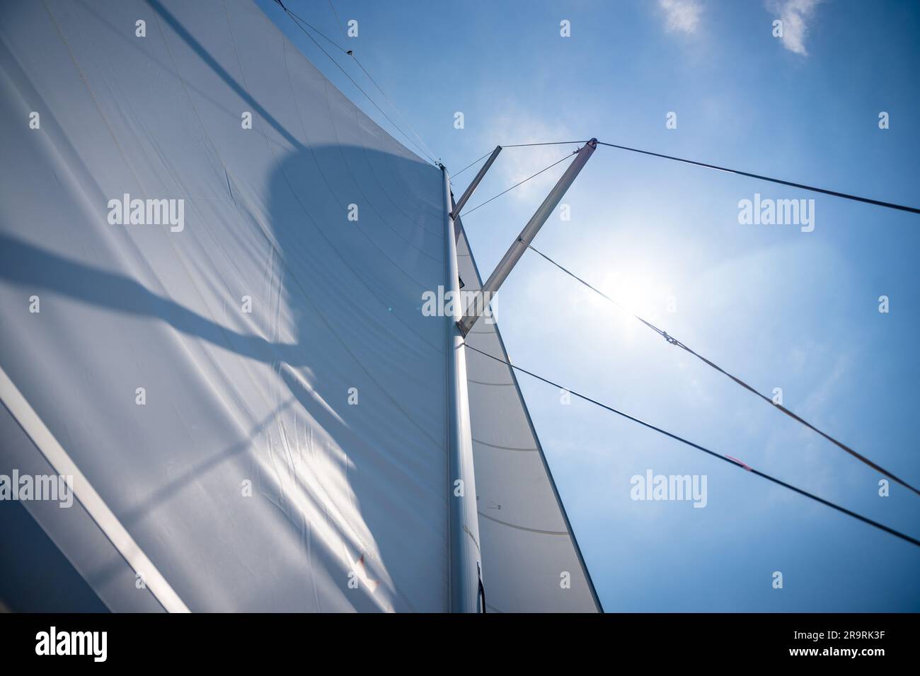 Yacht sailing in an open sea. Close-up view of sails of a sailing yacht ...