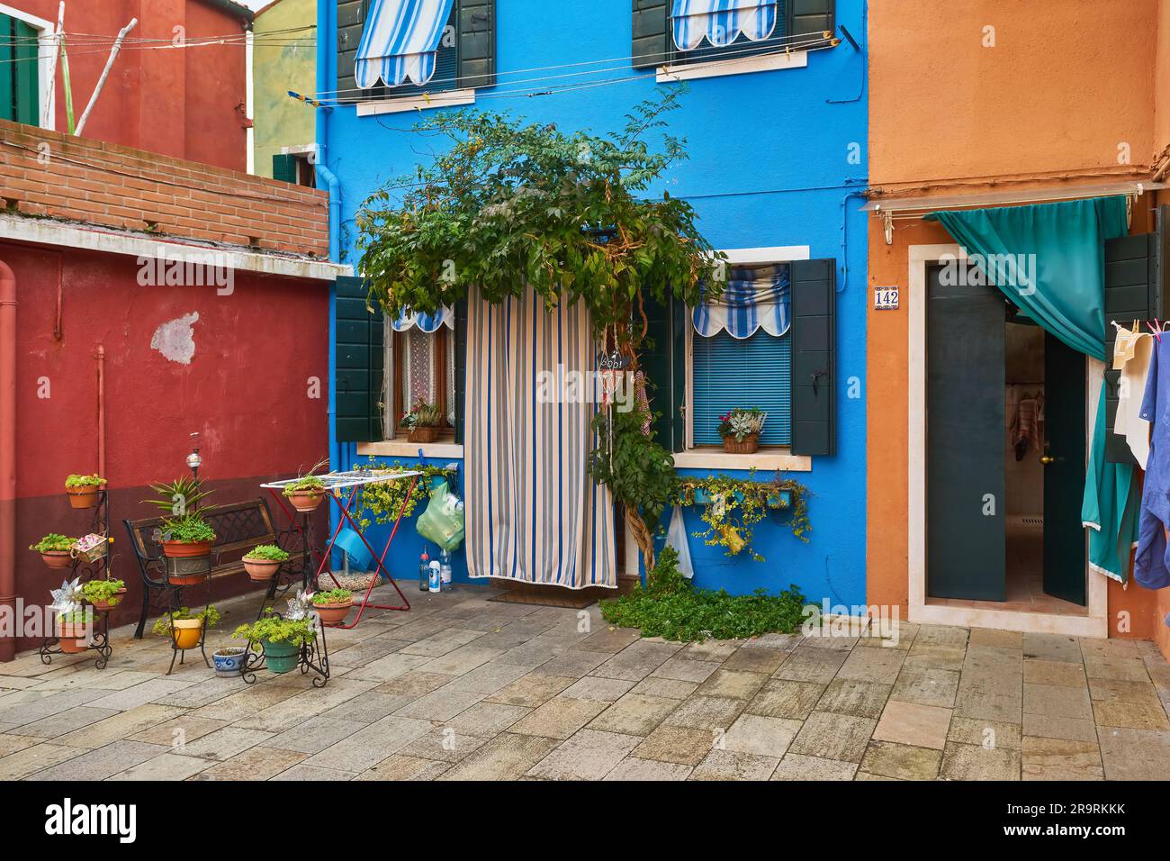 Blue facade of the house with door and windows. Colorful architecture ...