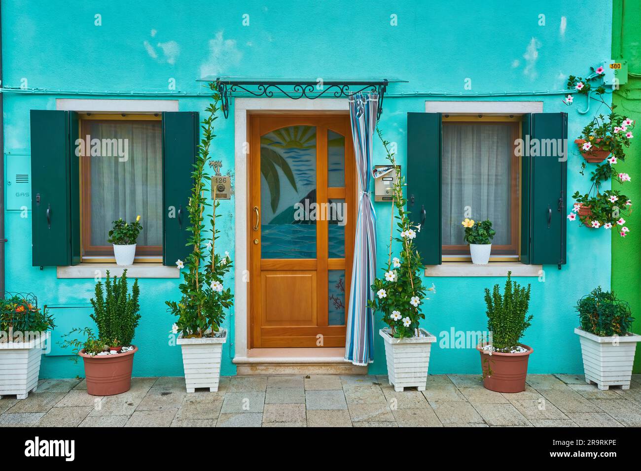 Blue facade of the house with door and windows. Colorful architecture ...
