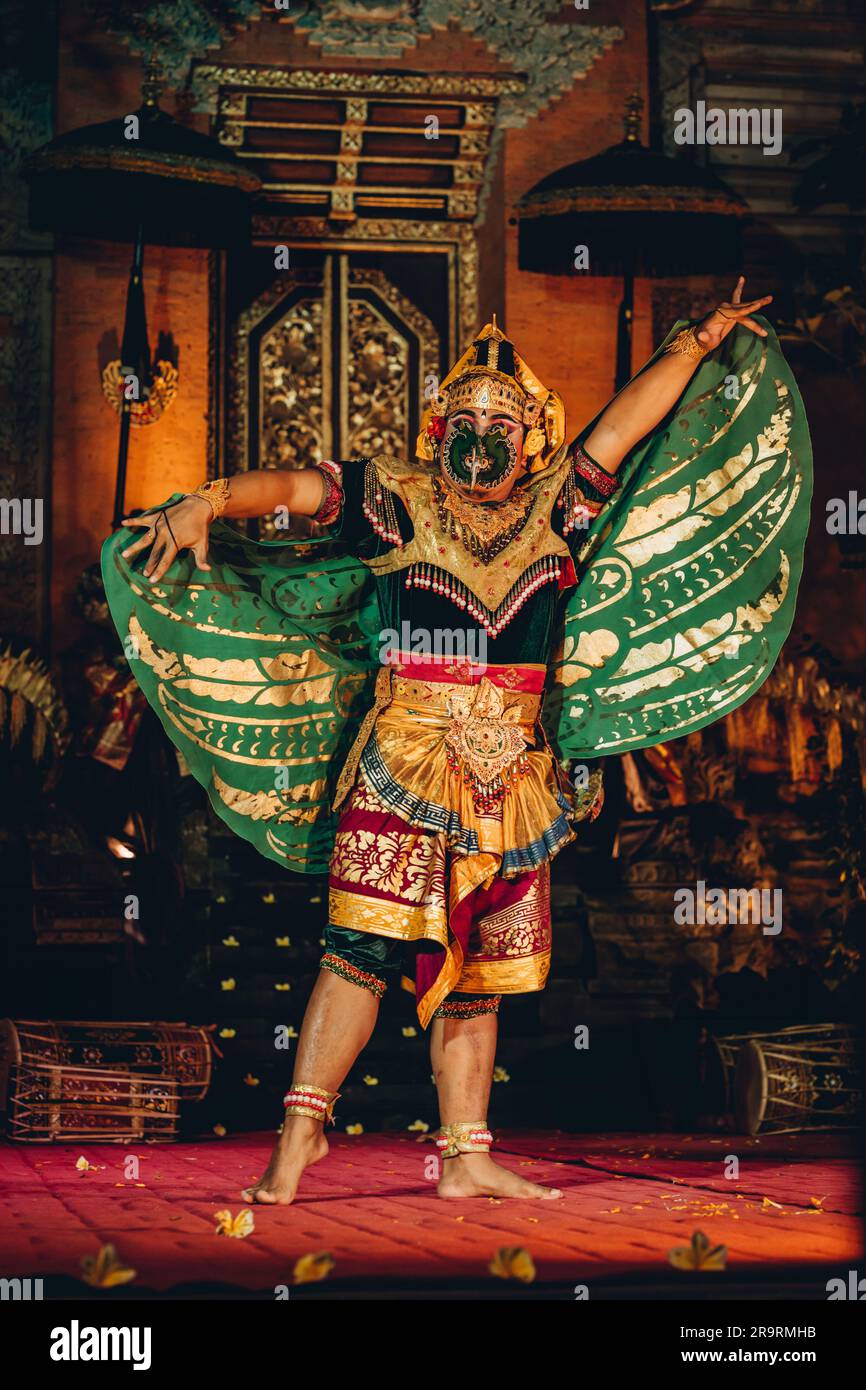 Unrecognisable Balinese artist dancing with show mask. Traditional bali ...