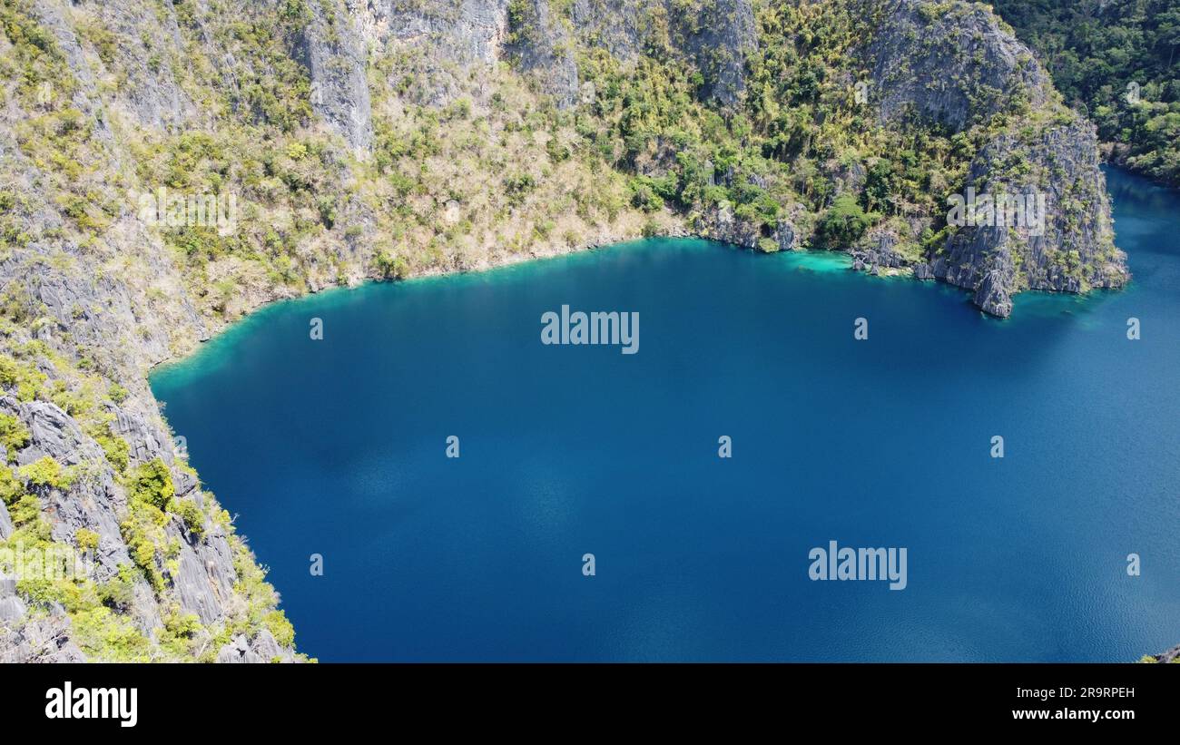 A tranquil blue lagoon situated in a remote location, surrounded by ...
