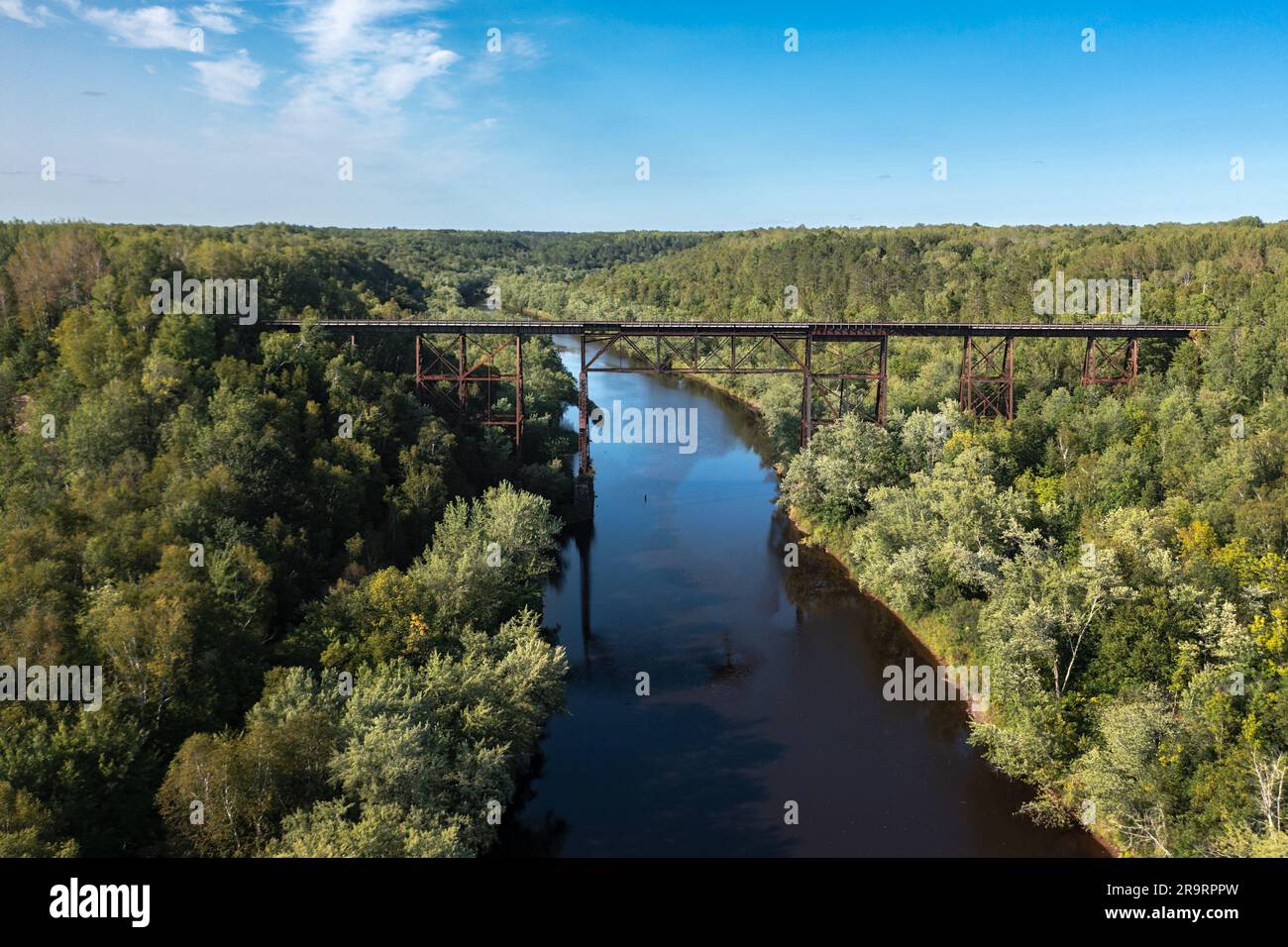 Railroad Trestle Bridge Passes Over River and Forest - drone aerial ...