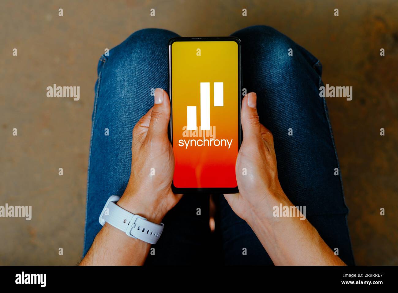 In this photo illustration, the Synchrony logo is displayed on a ...