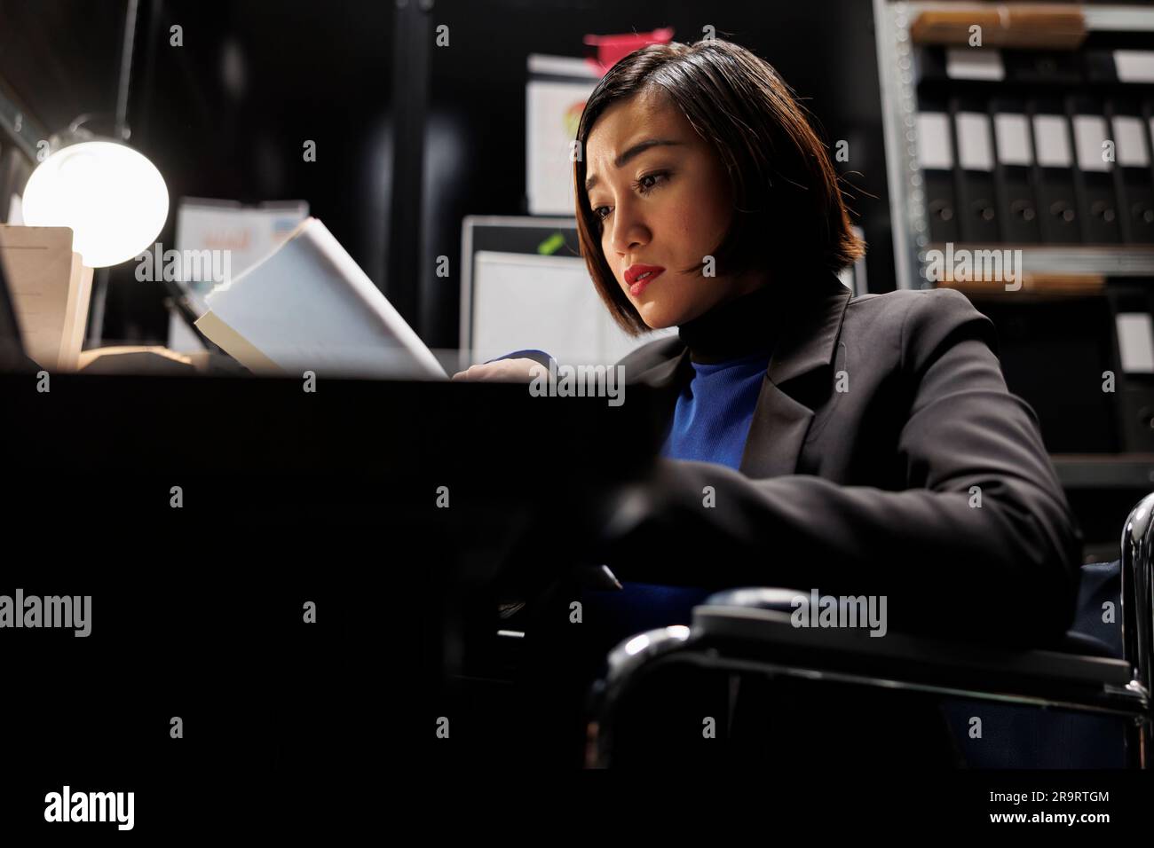 Paralyzed businesswoman executive in wheelchair checking accountancy ...