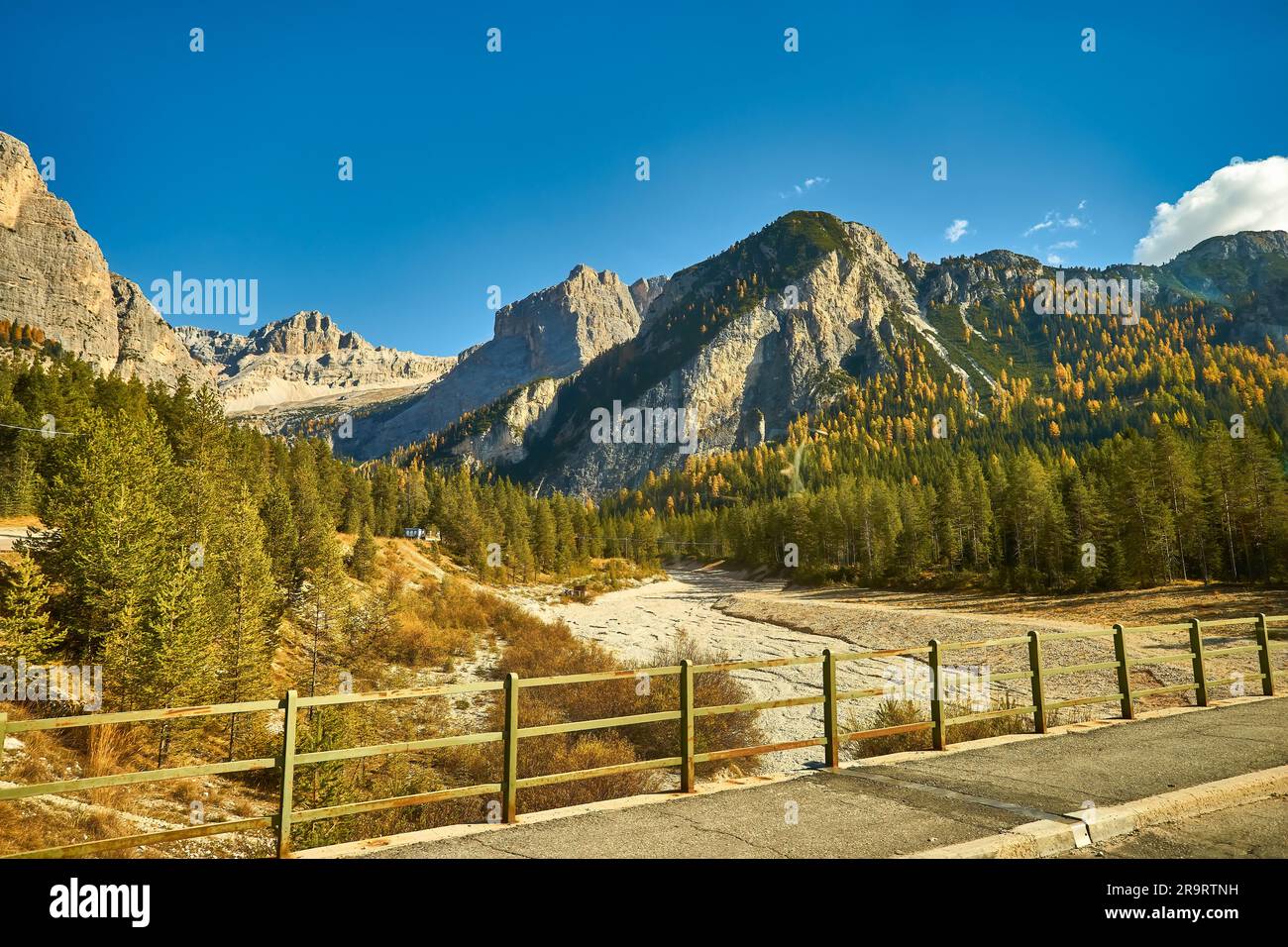 Stunning alpine Landscape at sautumn sunny day. Alpine meadow and road ...