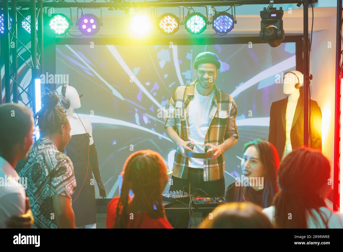 People dancing and enjoying dj show at disco party in nightclub. Young ...