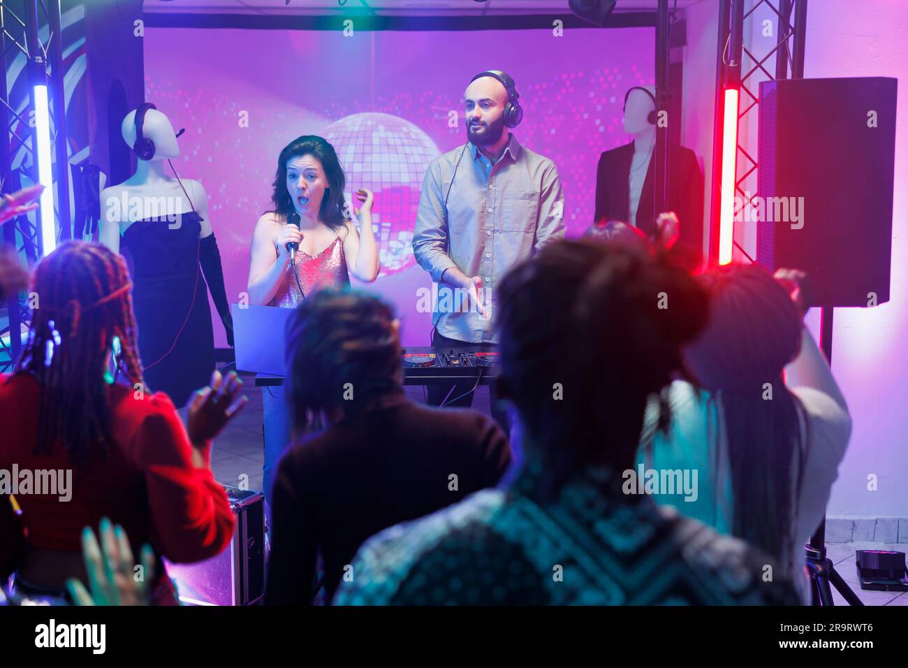 Band singing and playing on stage while performing live at nightclub ...