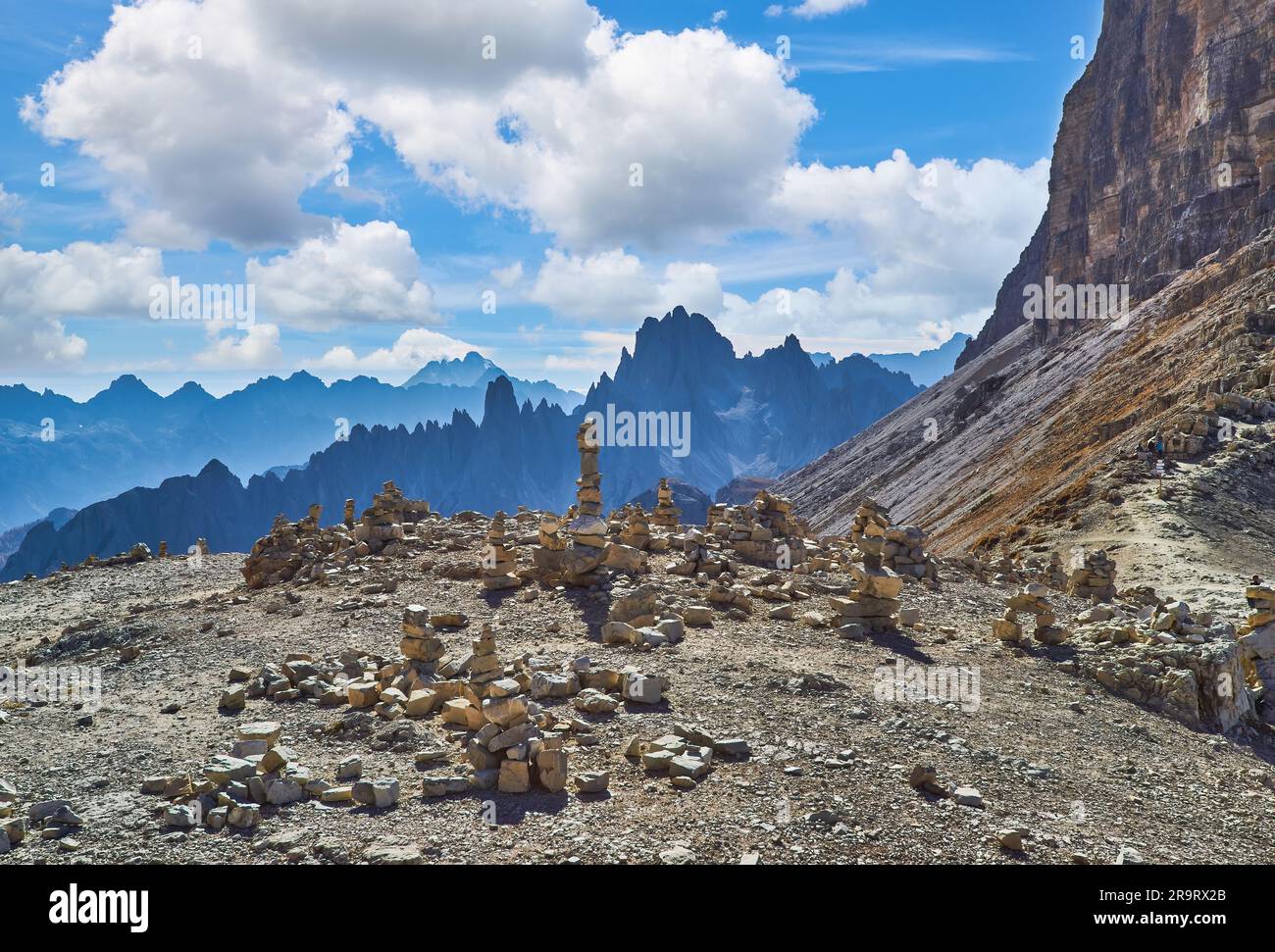 Stones gravel stack bellow Alpine mountain summit. Spring trail around ...
