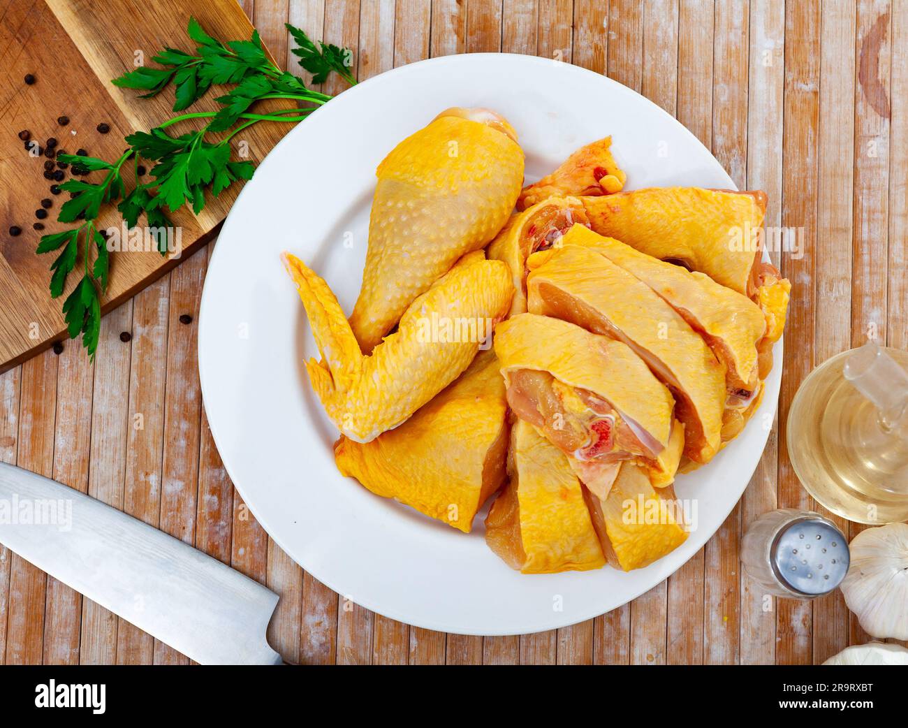 Pieces of unprepared chicken on table Stock Photo - Alamy