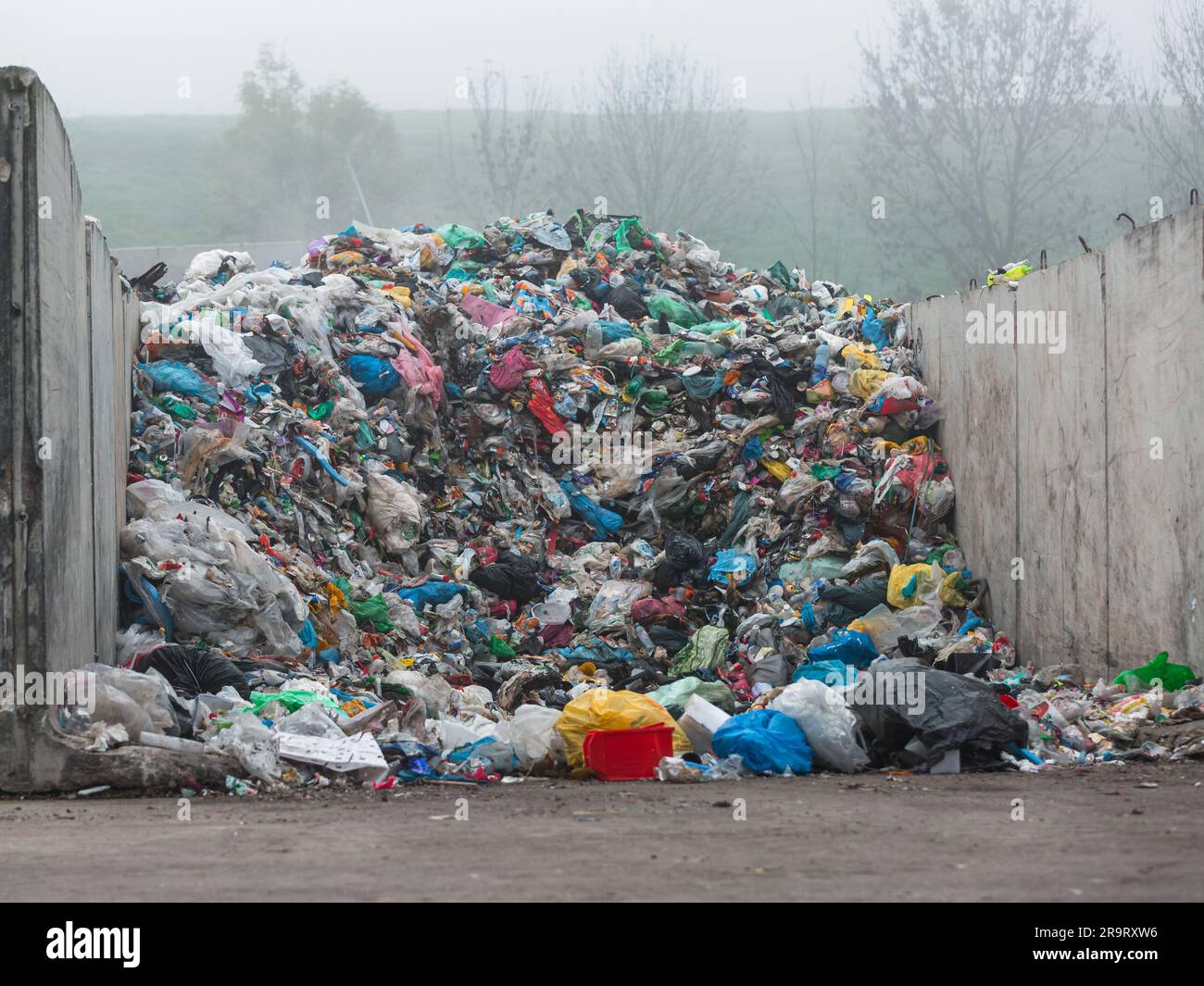 Landfill site, a pile of stinky different junk disposal in the concrete ...