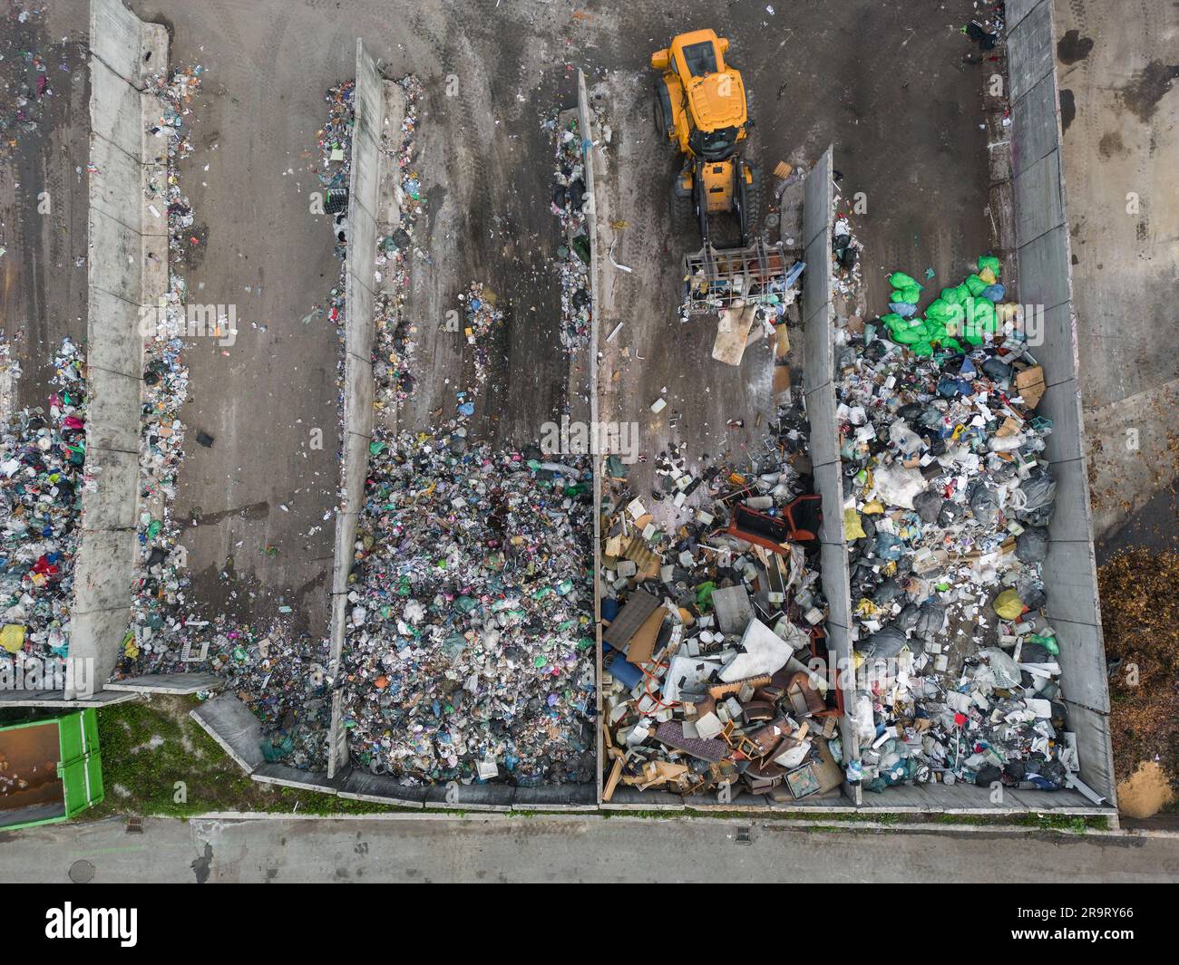 Process of moving a pile of waste with heavy equipment, wheel loader at ...