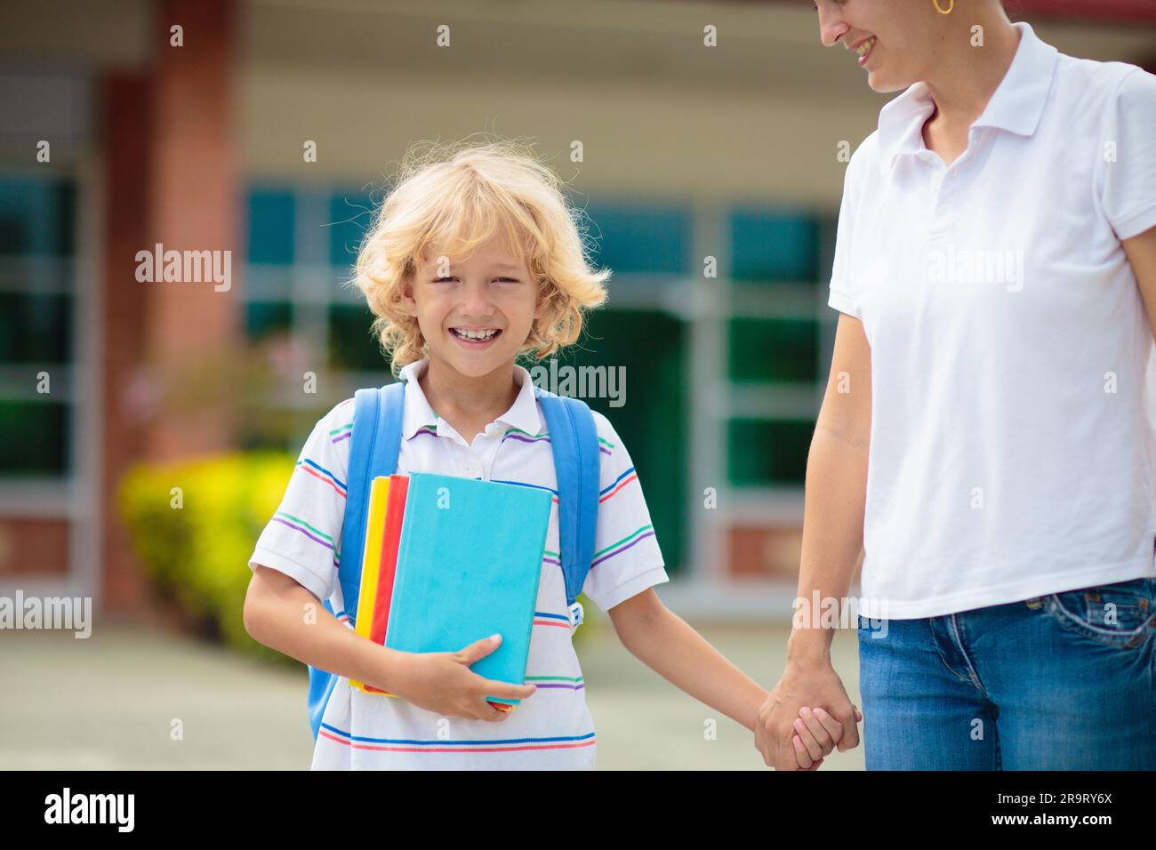 Mother bringing child to school. Parents pick up little boy after class ...