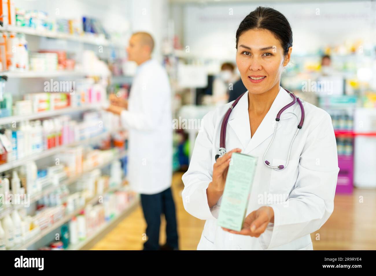 Female pharmacist offers various body care medicines Stock Photo - Alamy