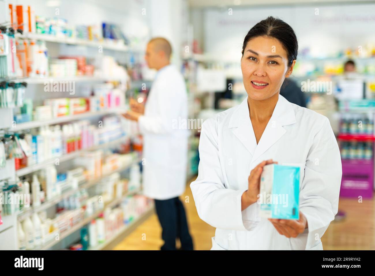 Female pharmacist offers various body care medicines Stock Photo - Alamy