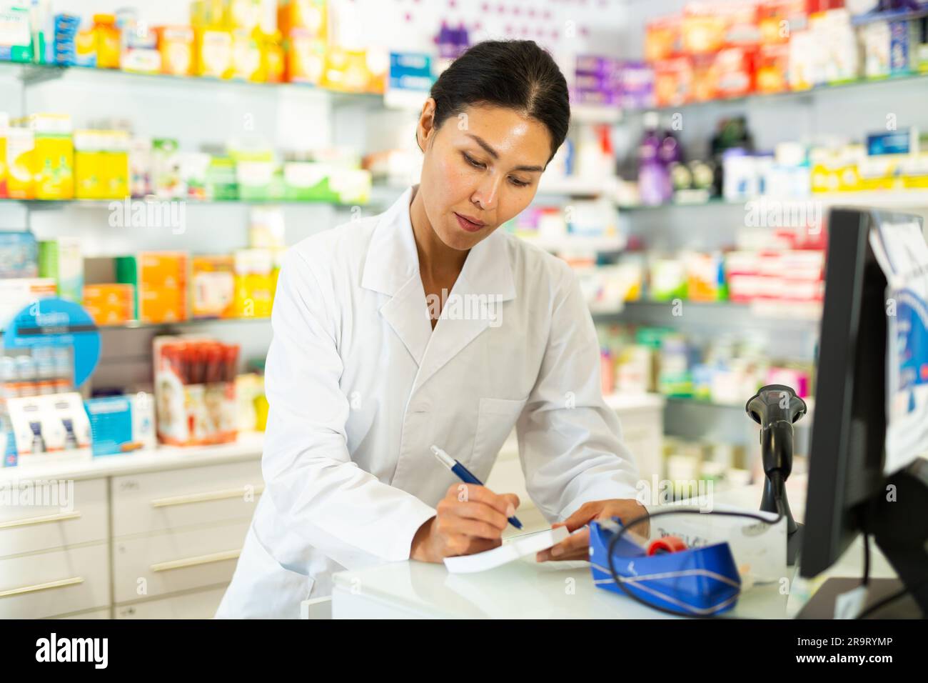Female pharmacist working in pharmacy, using computer screen Stock ...