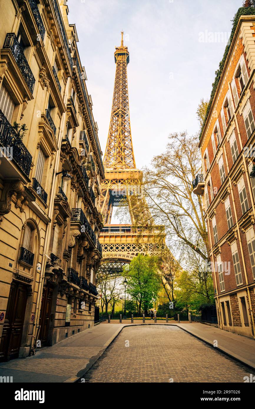 View of the Eiffel Tower from a nearby street full of residential ...