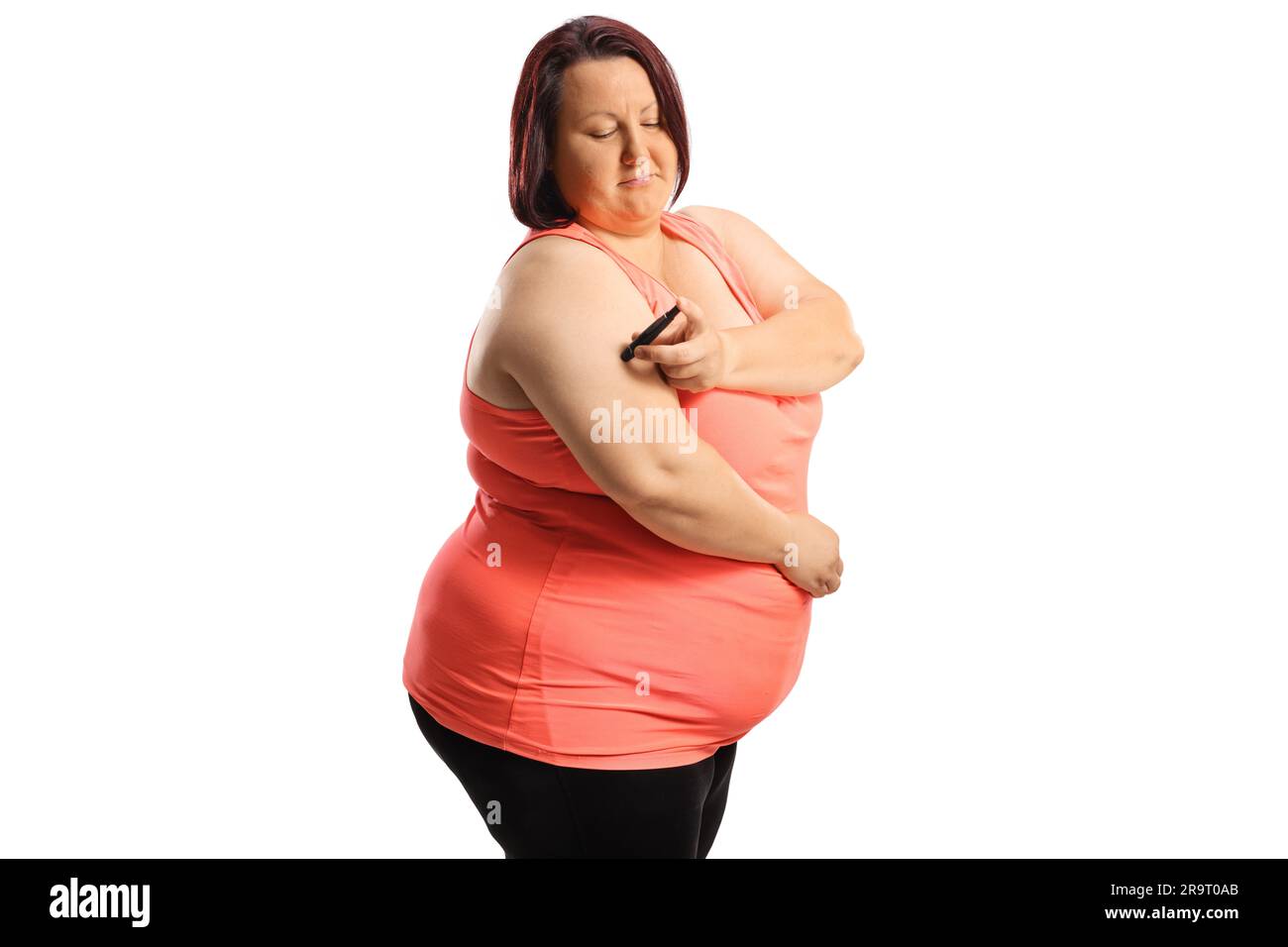 Overweight woman poking arm with an insulin pen isolated on white ...